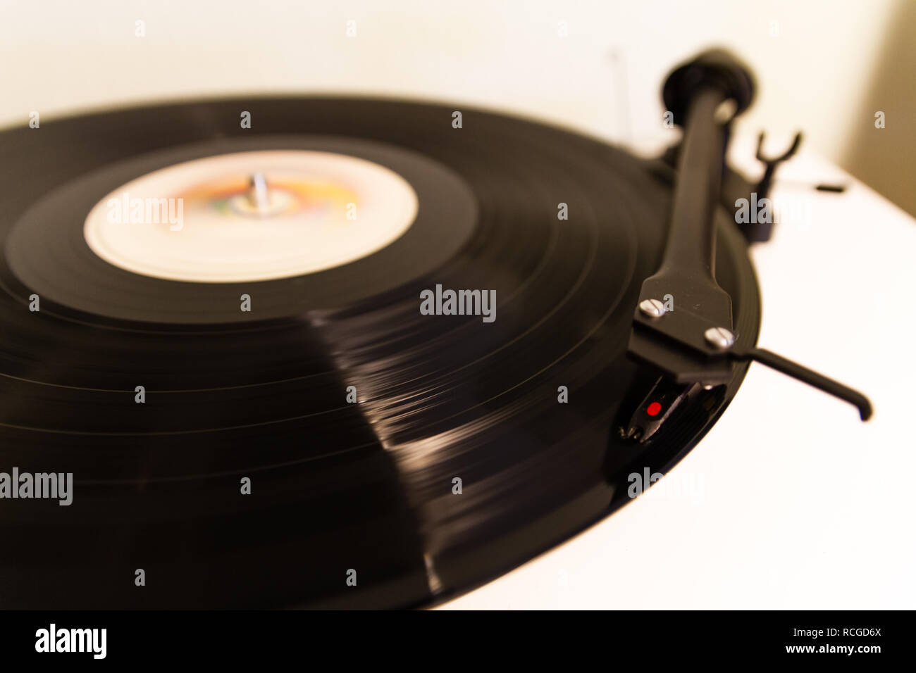 Vinyl lp record playing on a turntable isolated Stock Photo - Alamy