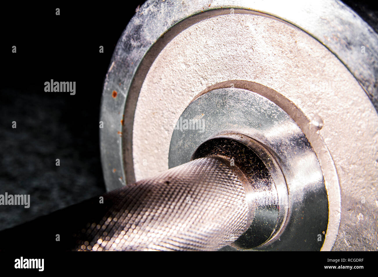 Heavy metal weight on a gym floor Stock Photo - Alamy