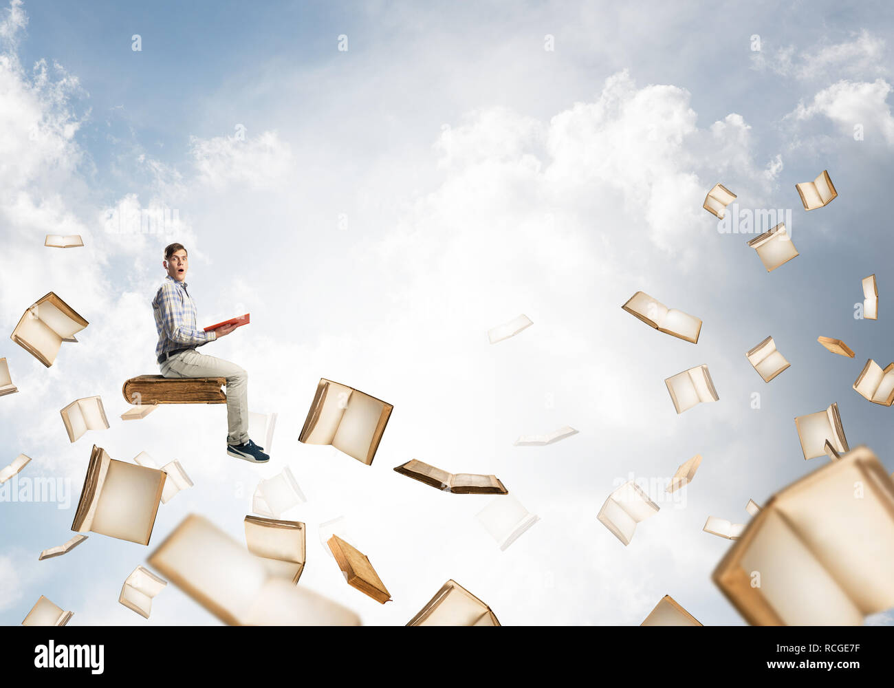 Man reading book and many of them flying in air Stock Photo - Alamy