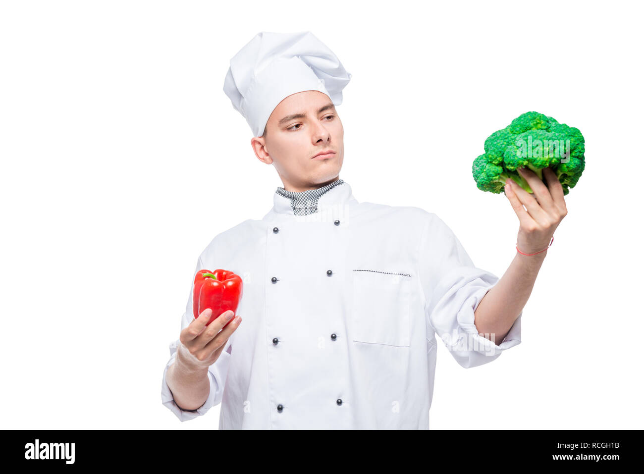 Difficult choice of pepper or broccoli - concept portrait of a chef ...