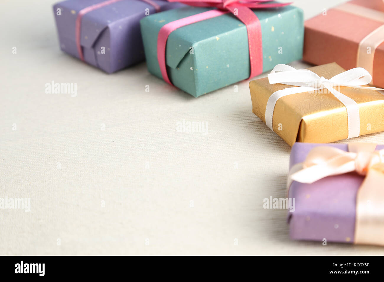 Many gift boxes on beige fabric texture background Stock Photo - Alamy