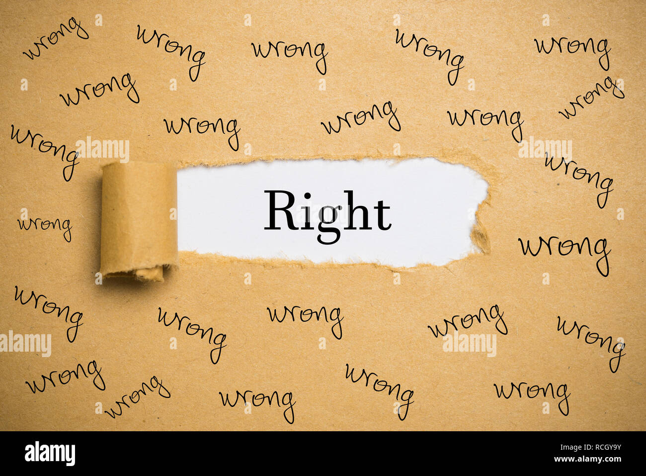 torn paper revealing the word "right" surrounded by the word "wrong ...