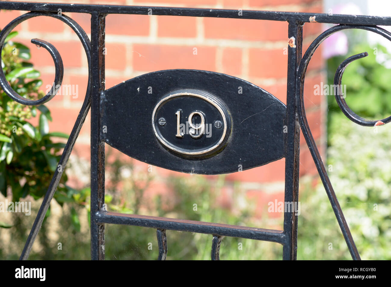 House number 19 sign on gate Stock Photo - Alamy
