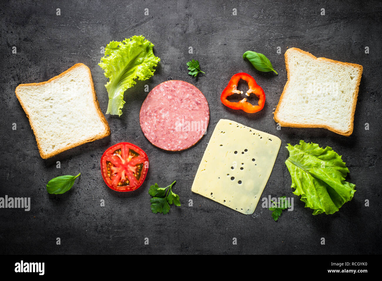 Ingredients for sandwich on a black background Stock Photo - Alamy