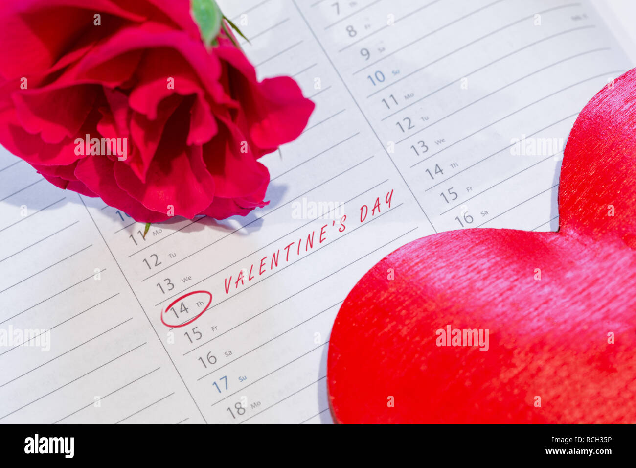 Marked the Valentine's day on calendar with rose and heart Stock Photo ...