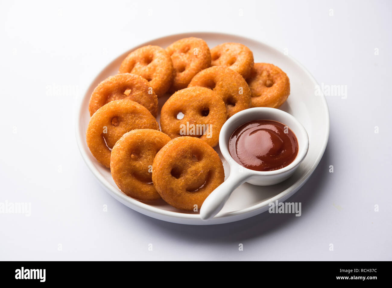 Crunchy potato smiling face chips or fried smile faced snacks served ...
