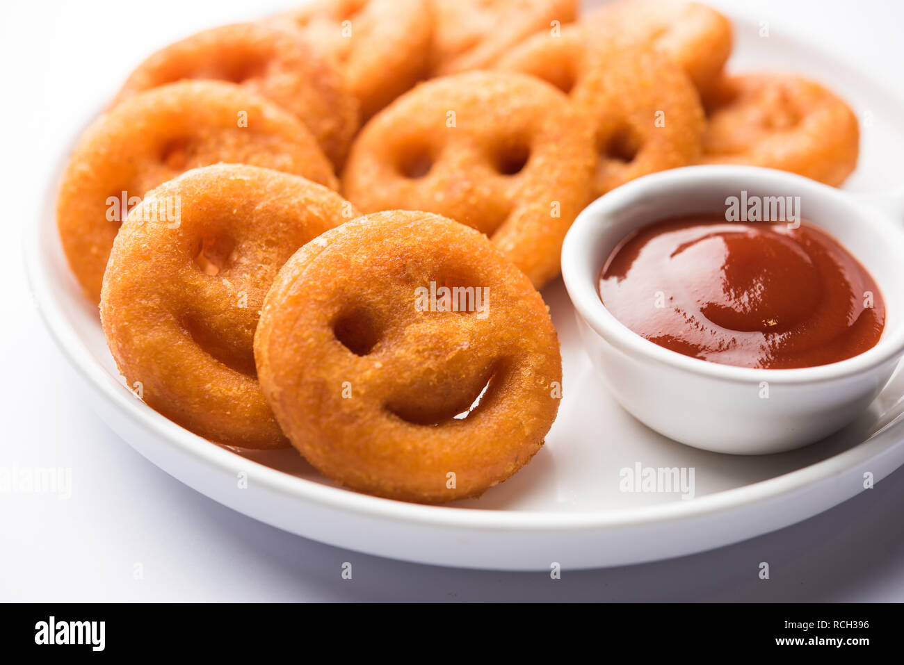 Crunchy potato smiling face chips or fried smile faced snacks served ...