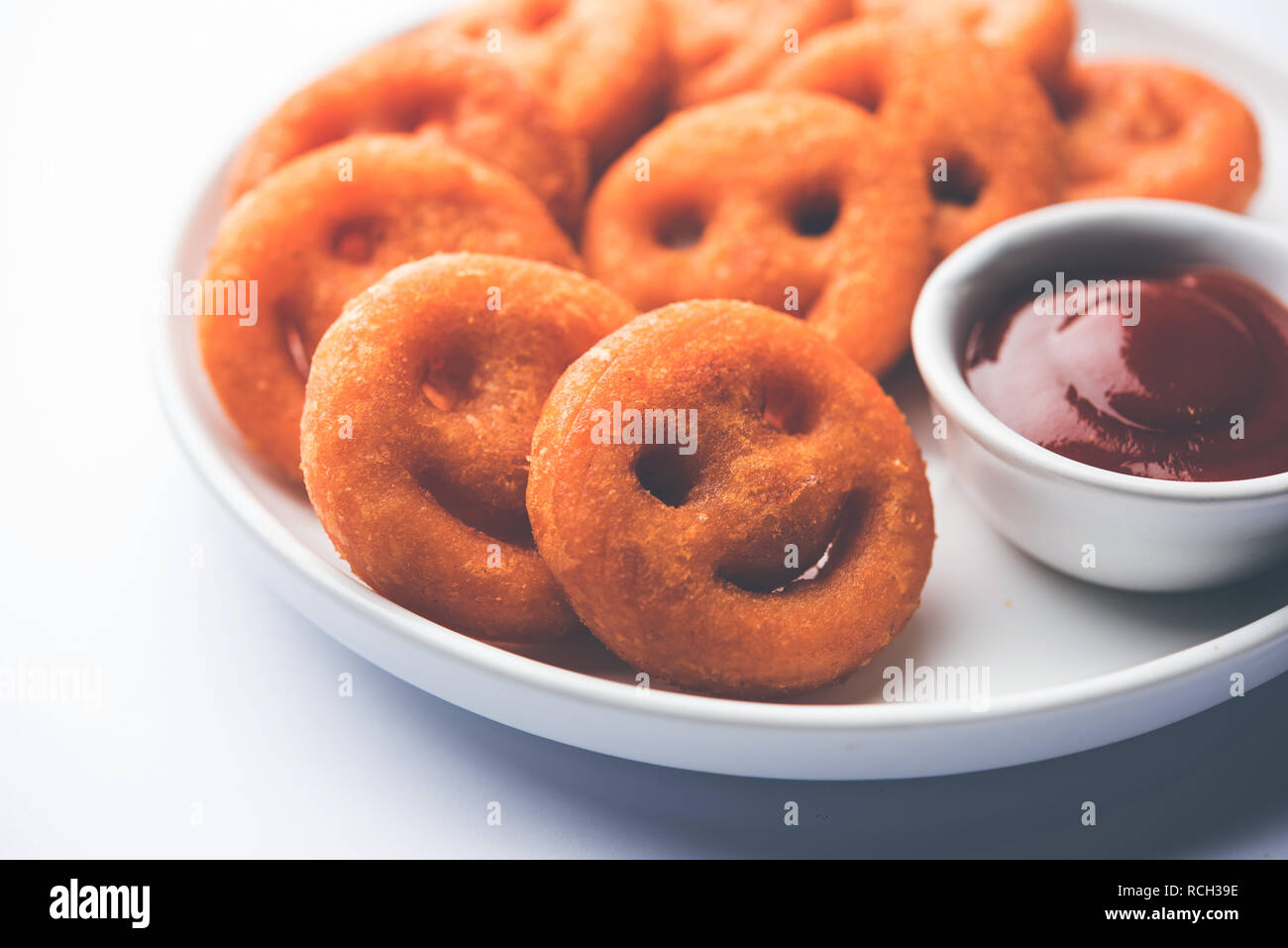 Crunchy potato smiling face chips or fried smile faced snacks served ...