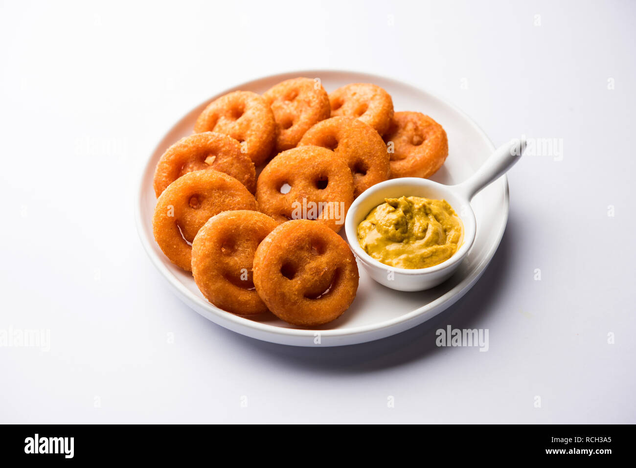 Crunchy potato smiling face chips or fried smile faced snacks served ...