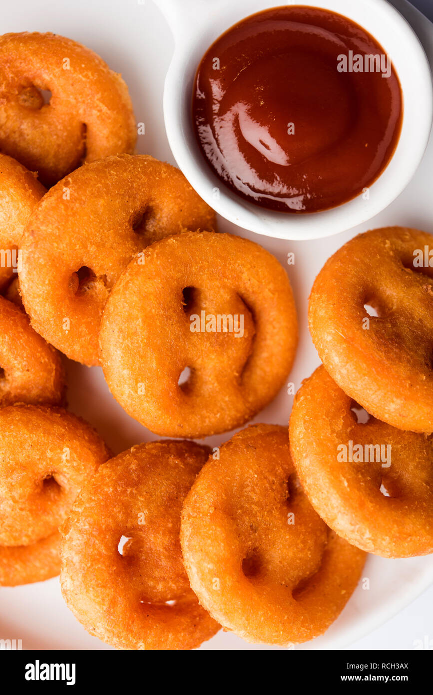 Crunchy potato smiling face chips or fried smile faced snacks served ...
