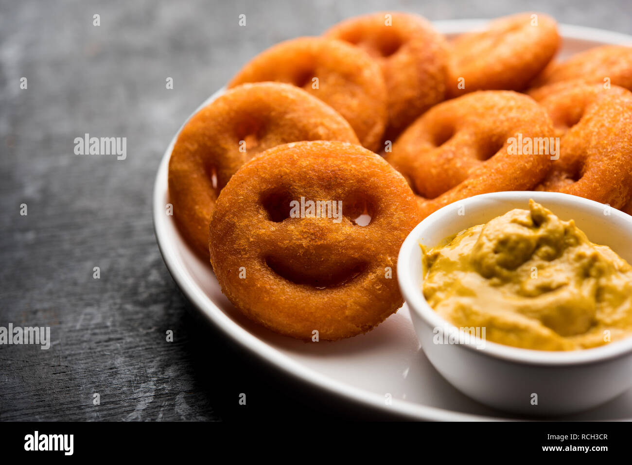 Crunchy potato smiling face chips or fried smile faced snacks served ...