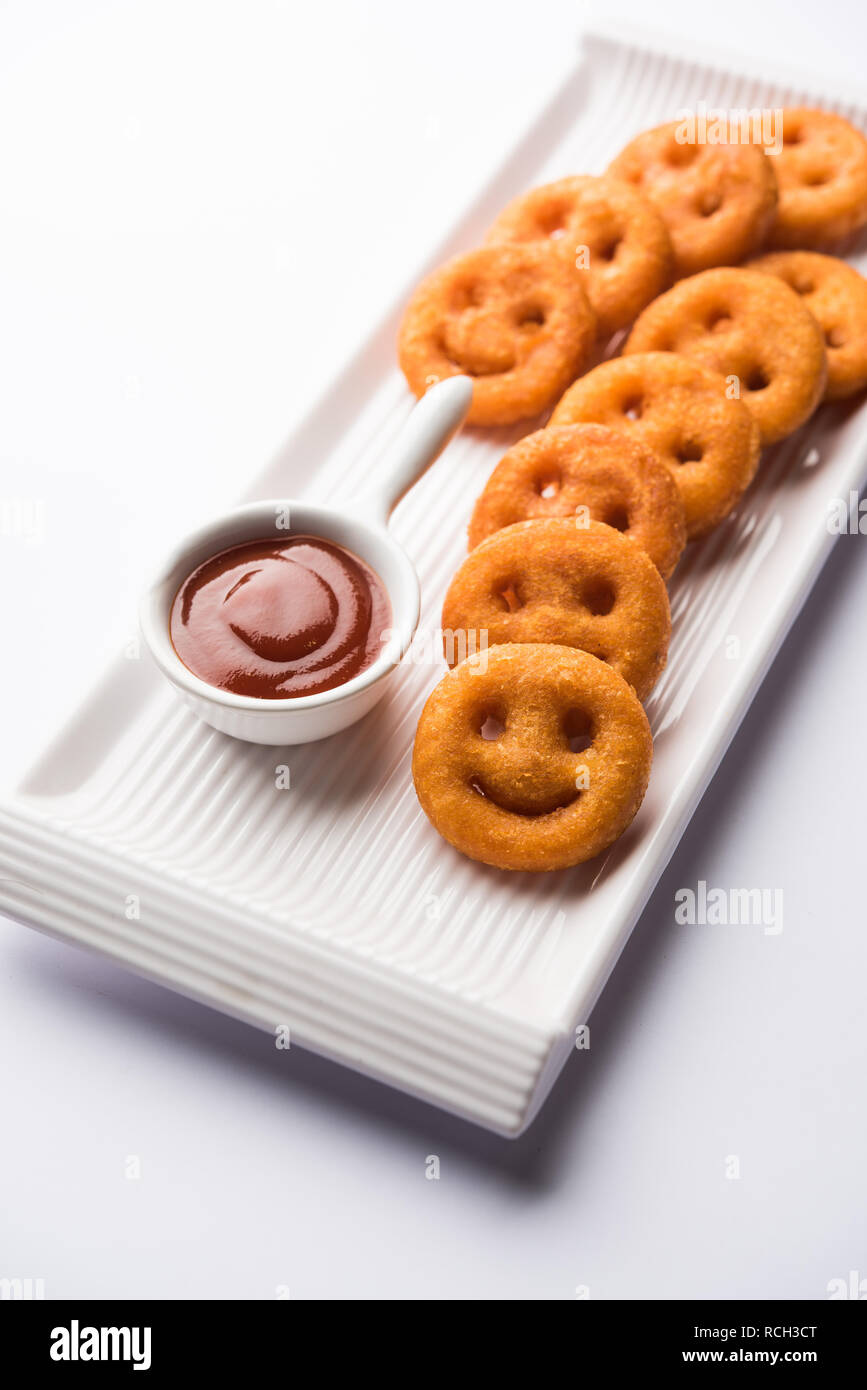 Crunchy potato smiling face chips or fried smile faced snacks served ...