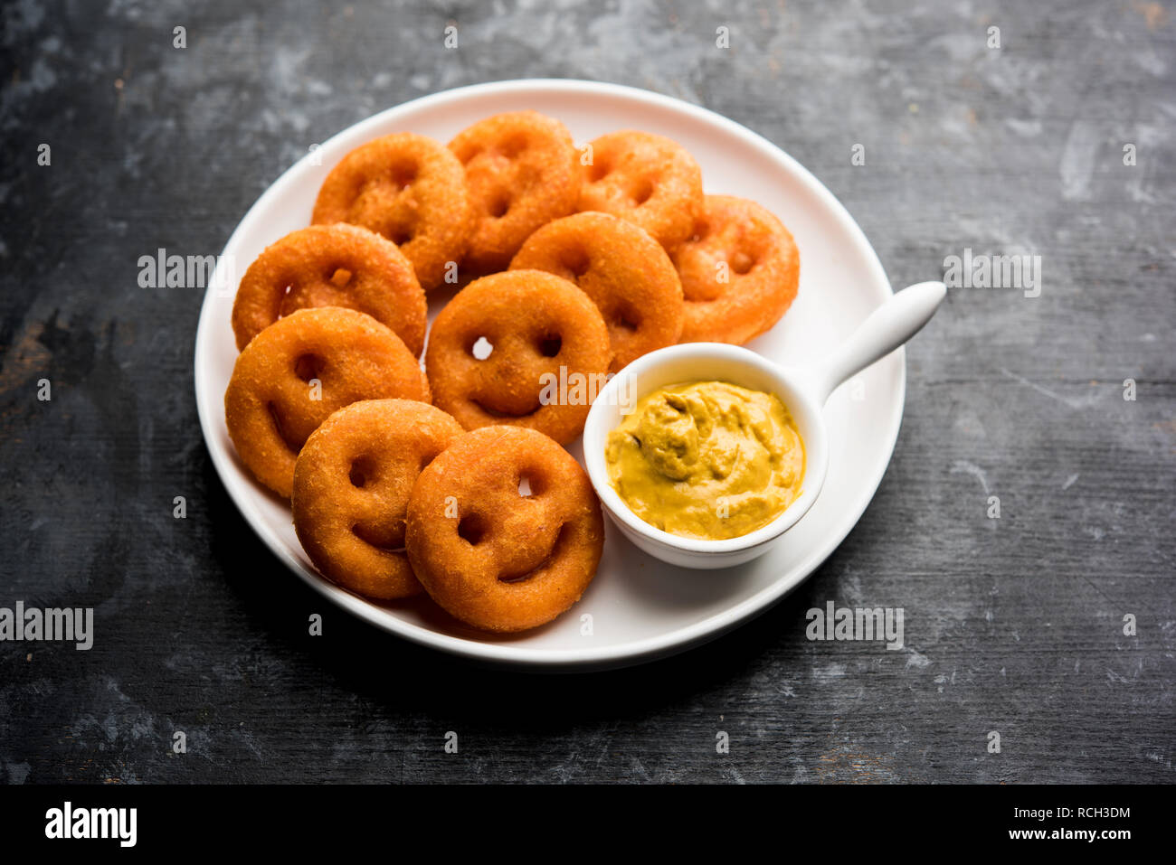 Crunchy potato smiling face chips or fried smile faced snacks served ...