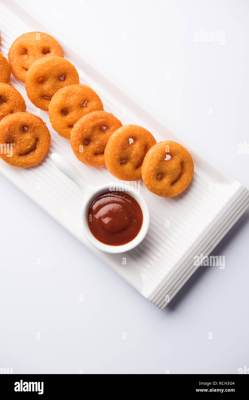 Crunchy potato smiling face chips or fried smile faced snacks served ...