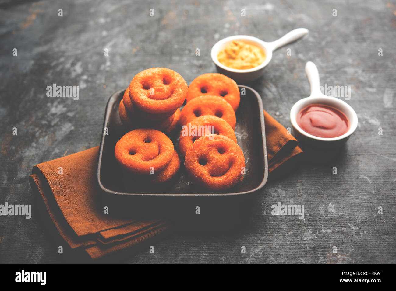 Crunchy potato smiling face chips or fried smile faced snacks served ...