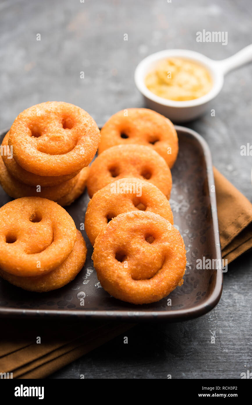 Crunchy potato smiling face chips or fried smile faced snacks served ...