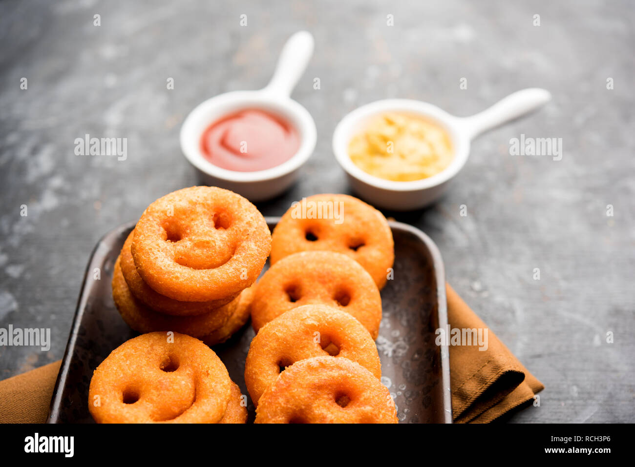 Crunchy potato smiling face chips or fried smile faced snacks served ...