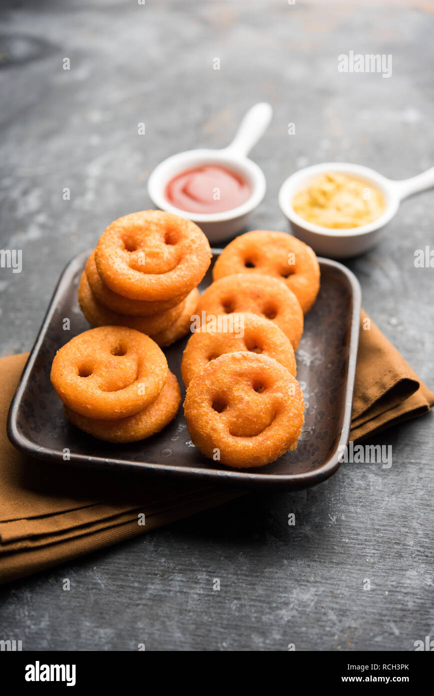 Crunchy potato smiling face chips or fried smile faced snacks served ...
