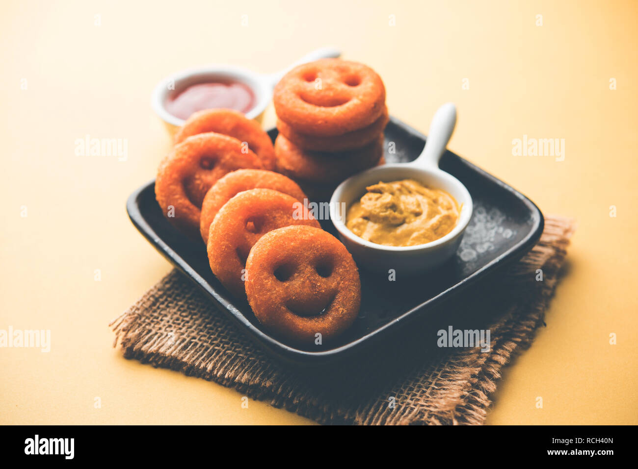 Crunchy potato smiling face chips or fried smile faced snacks served ...