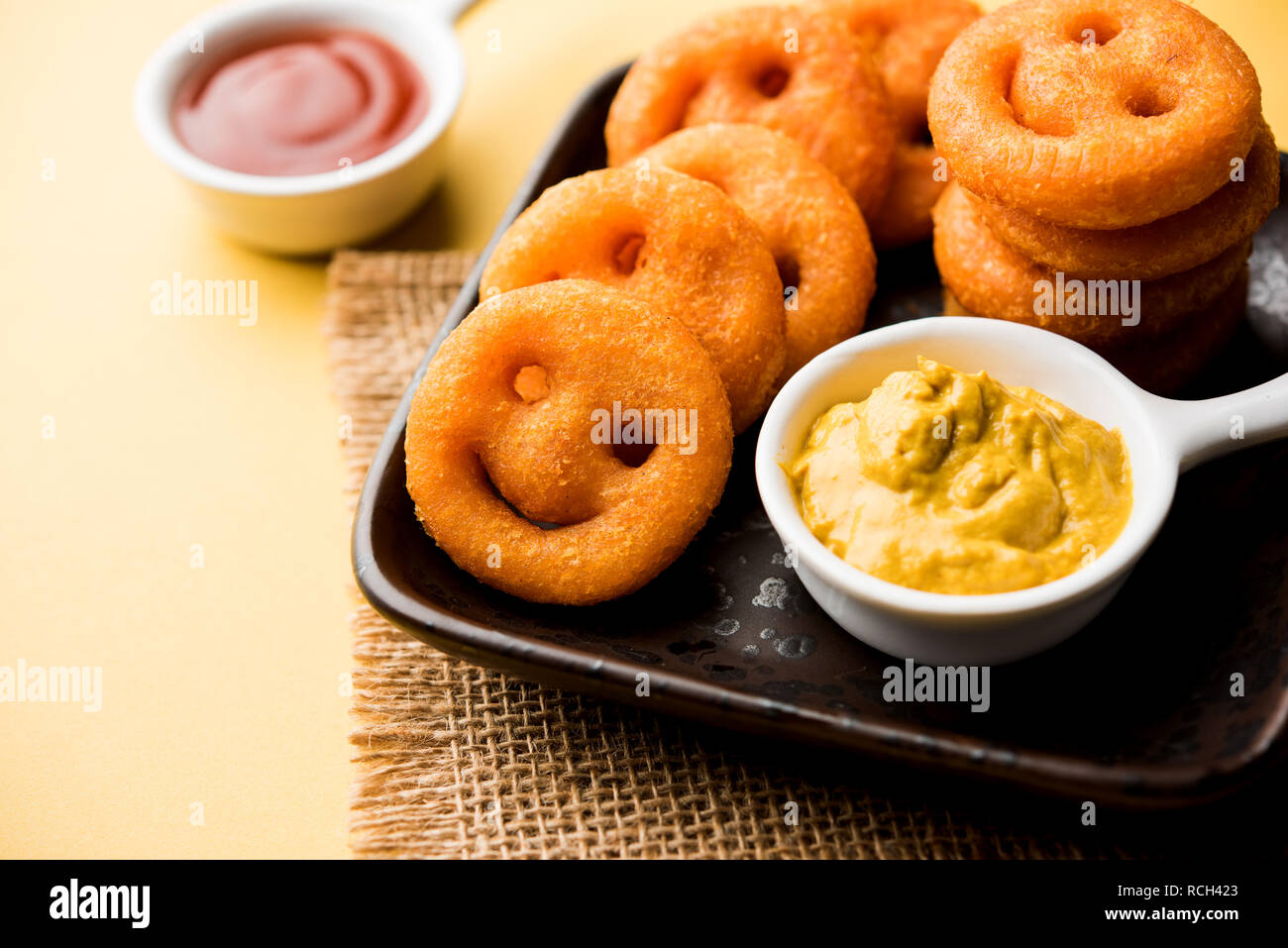 Crunchy potato smiling face chips or fried smile faced snacks served ...