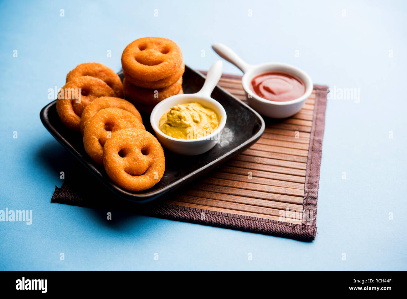 Crunchy potato smiling face chips or fried smile faced snacks served ...