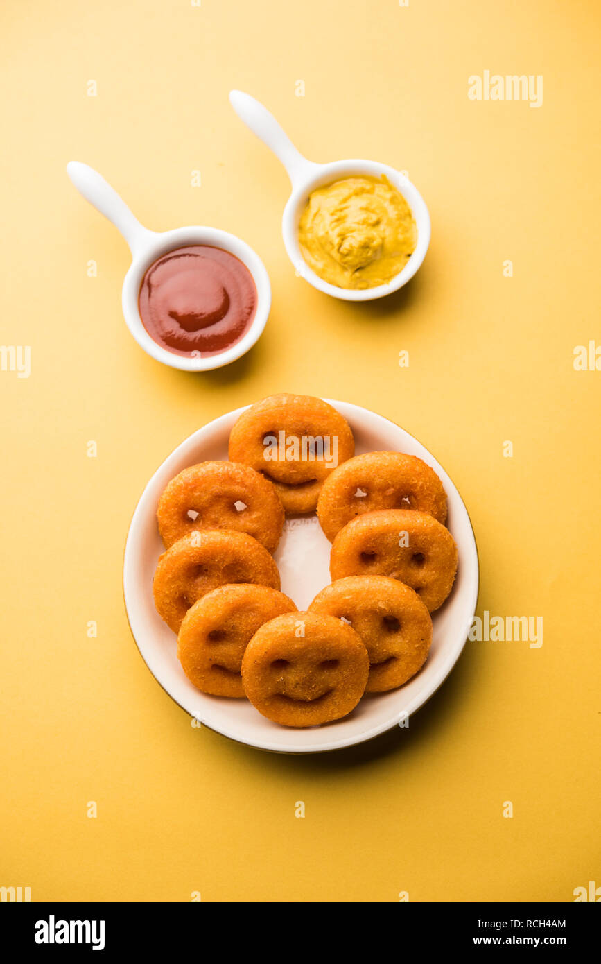 Crunchy potato smiling face chips or fried smile faced snacks served ...