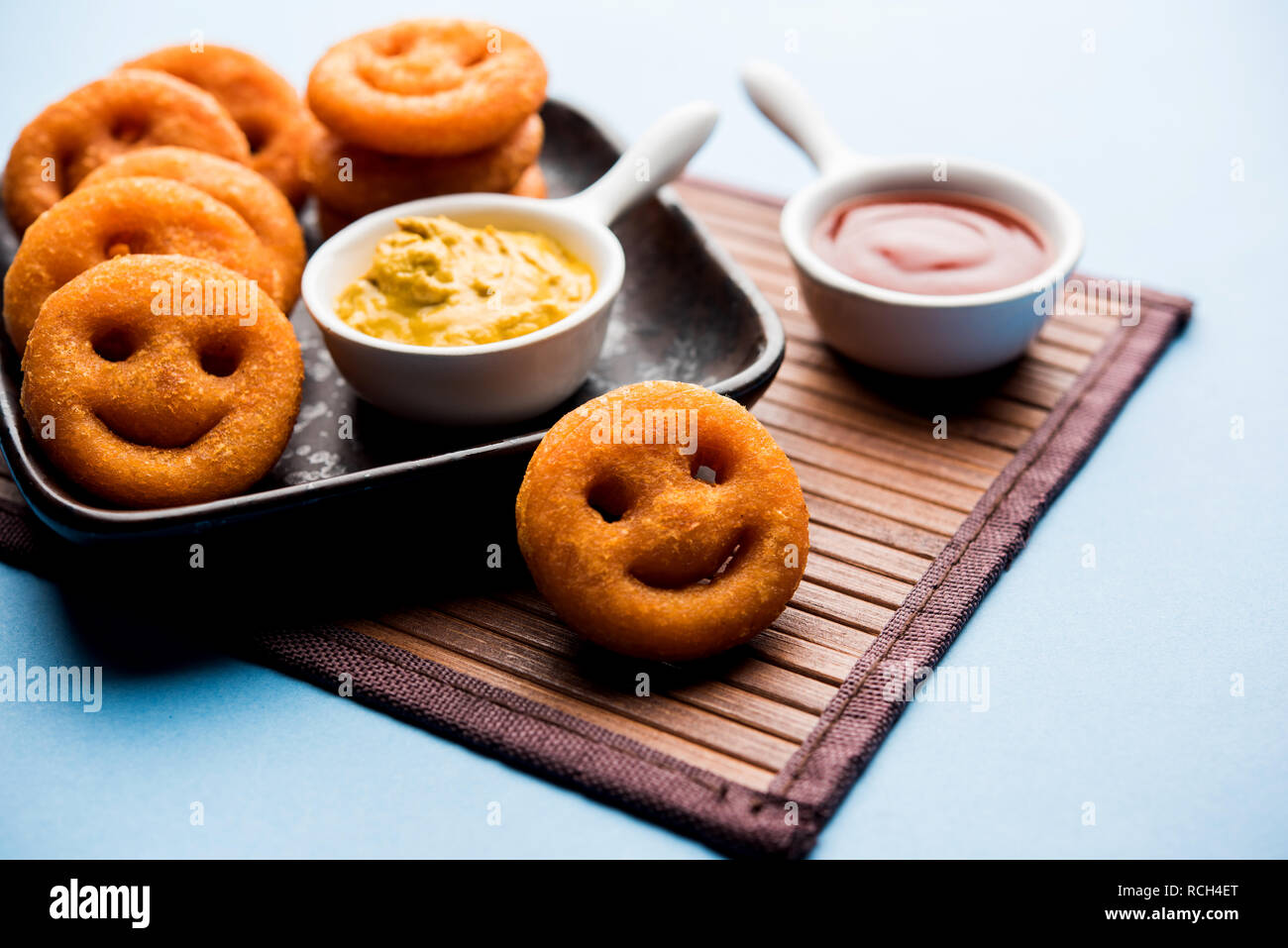 Crunchy potato smiling face chips or fried smile faced snacks served ...