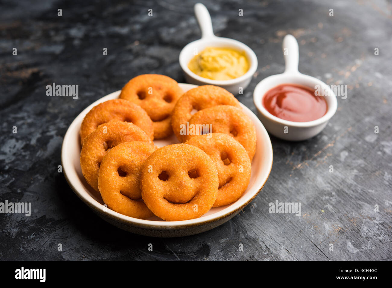 Crunchy potato smiling face chips or fried smile faced snacks served ...