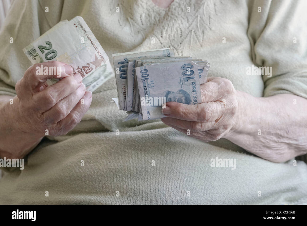closeup wrinkled hands of senior woman counting money (turkish lira ...