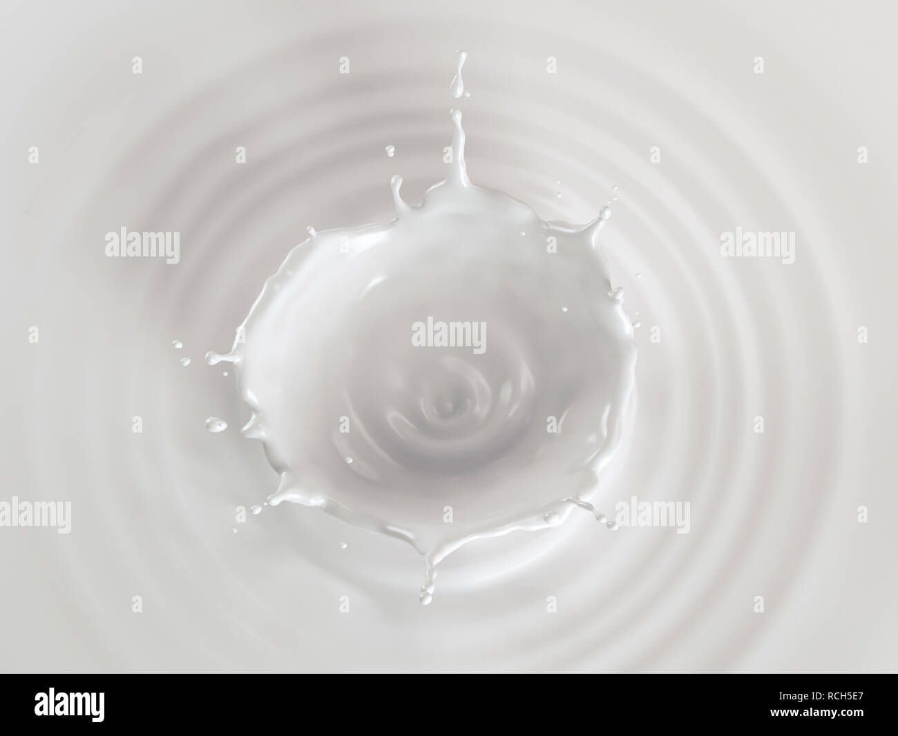 Milk crown splash in milk pool with circular ripples viewed from the ...