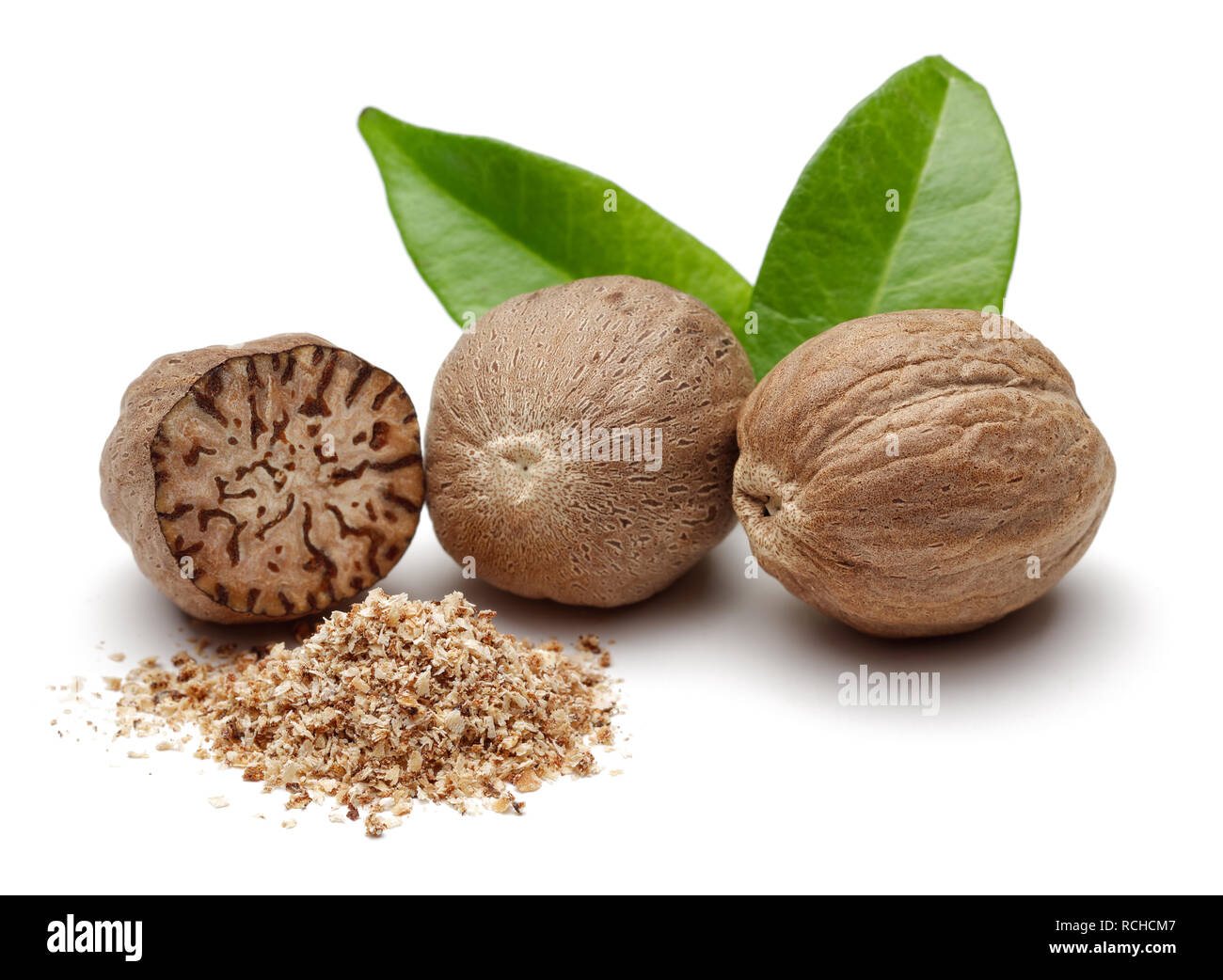 Nutmeg granules and nutmegs with leaves isolated on white background ...