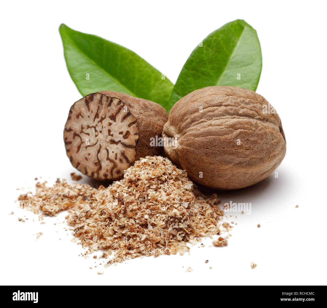 Nutmeg granules and nutmegs with leaves isolated on white background ...