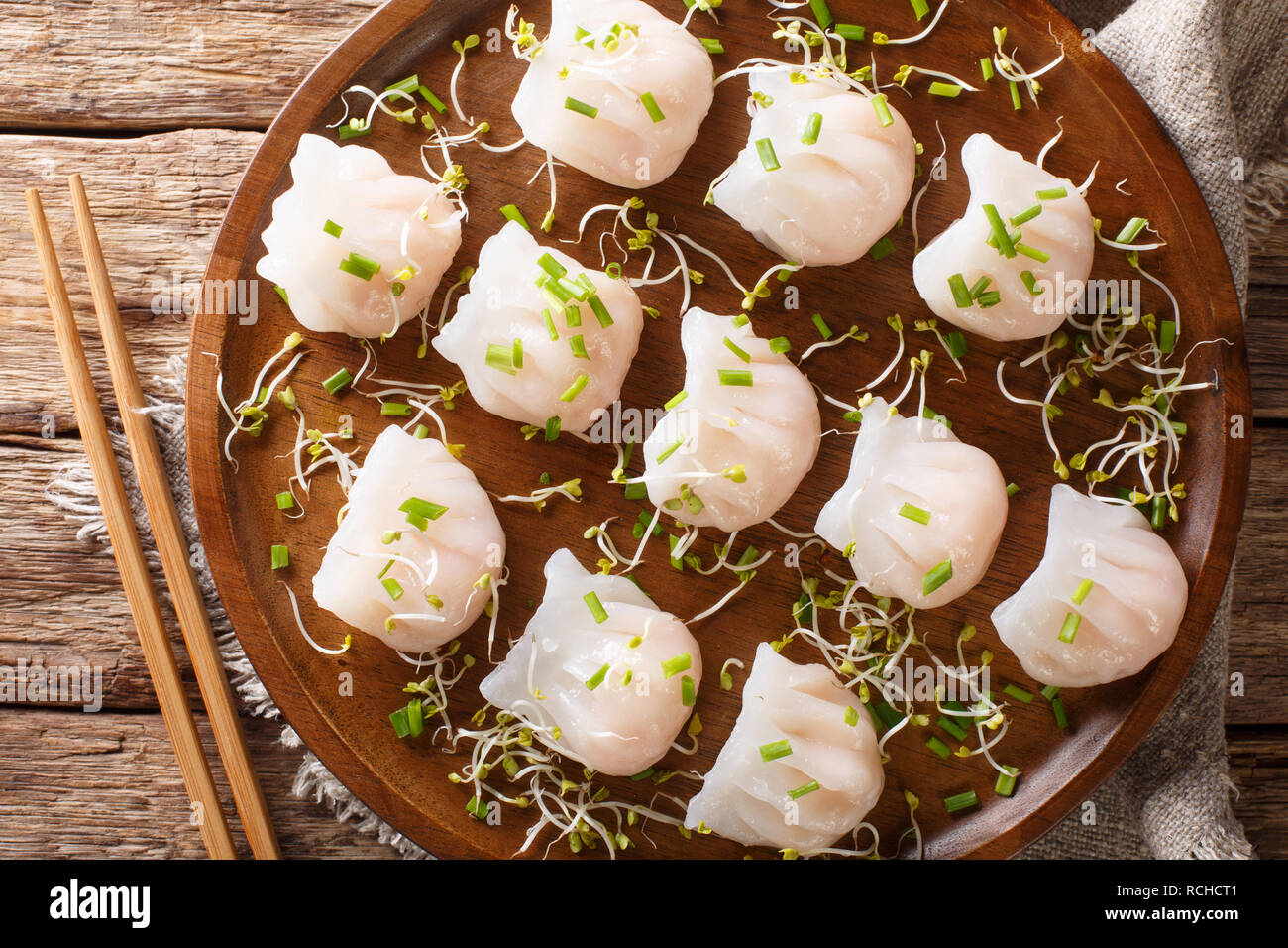 Delicious dumplings dim sum with shrimp served with sprouts close-up on ...