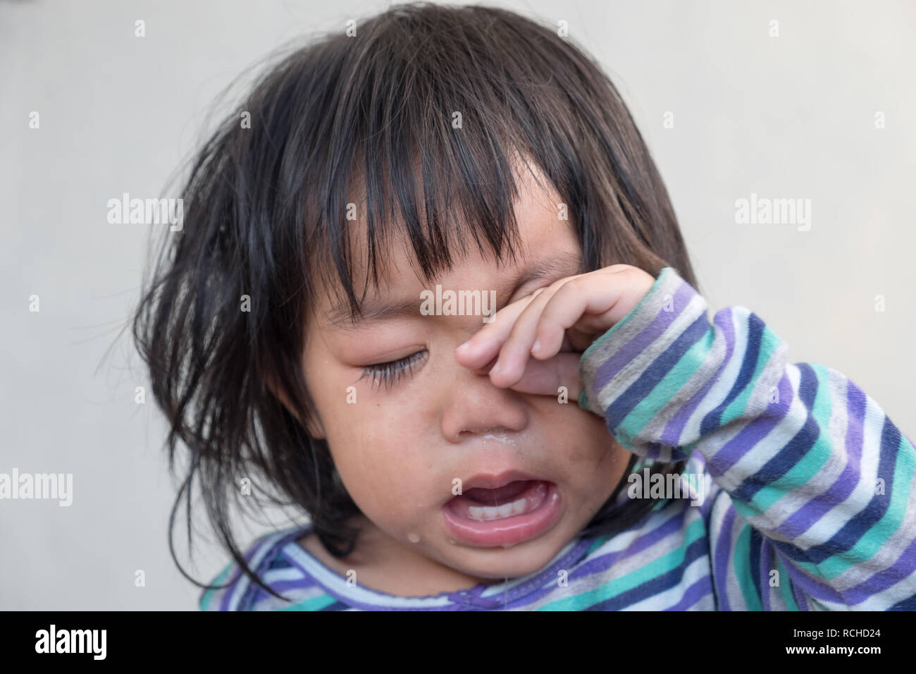 Emotional scene. Portrait of crying baby asian girl Stock Photo - Alamy