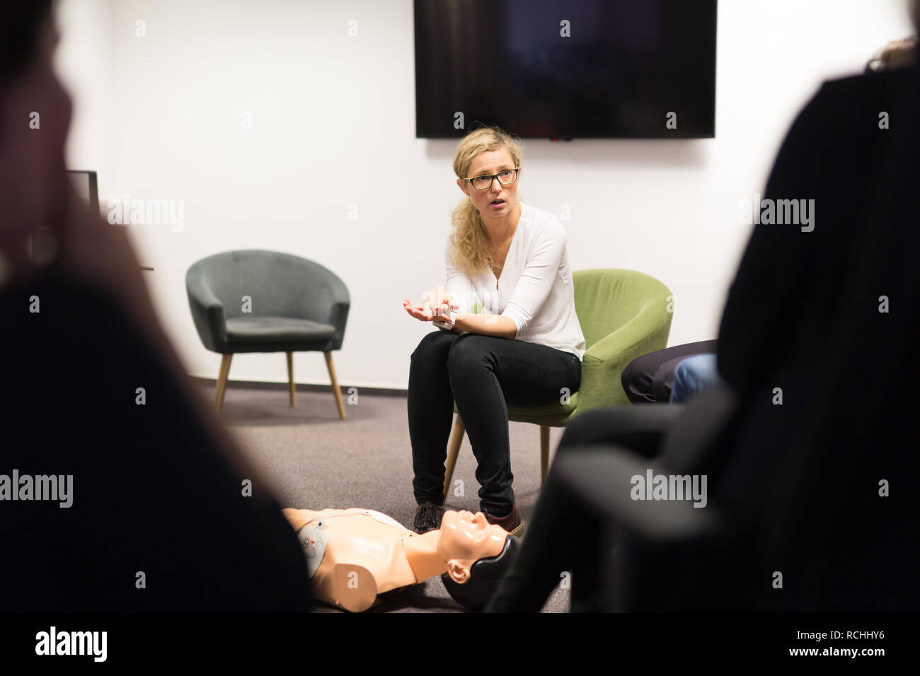 Instructor teaching first aid cardiopulmonary resuscitation course and ...