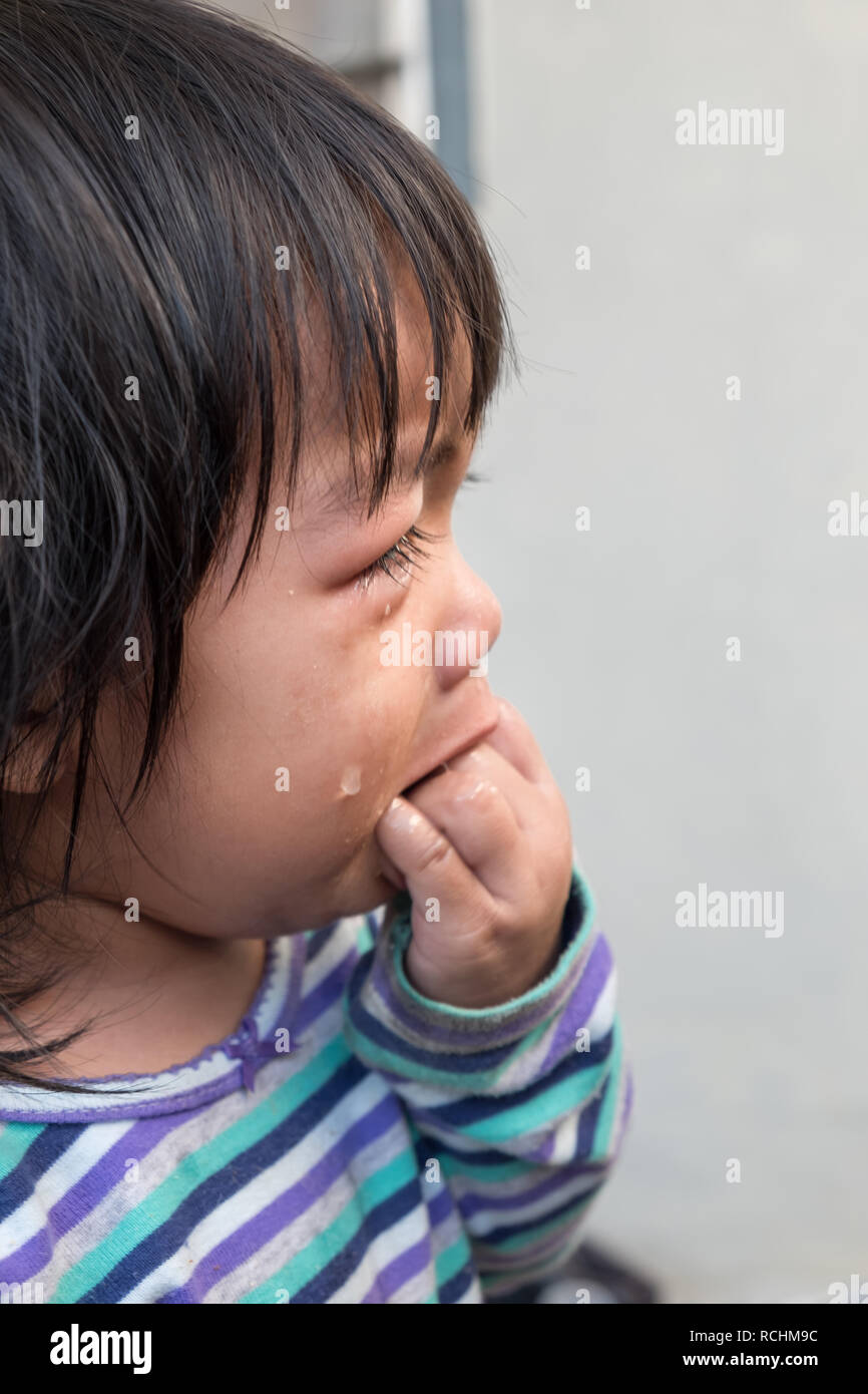 Emotional scene. Portrait of crying baby asian girl Stock Photo - Alamy