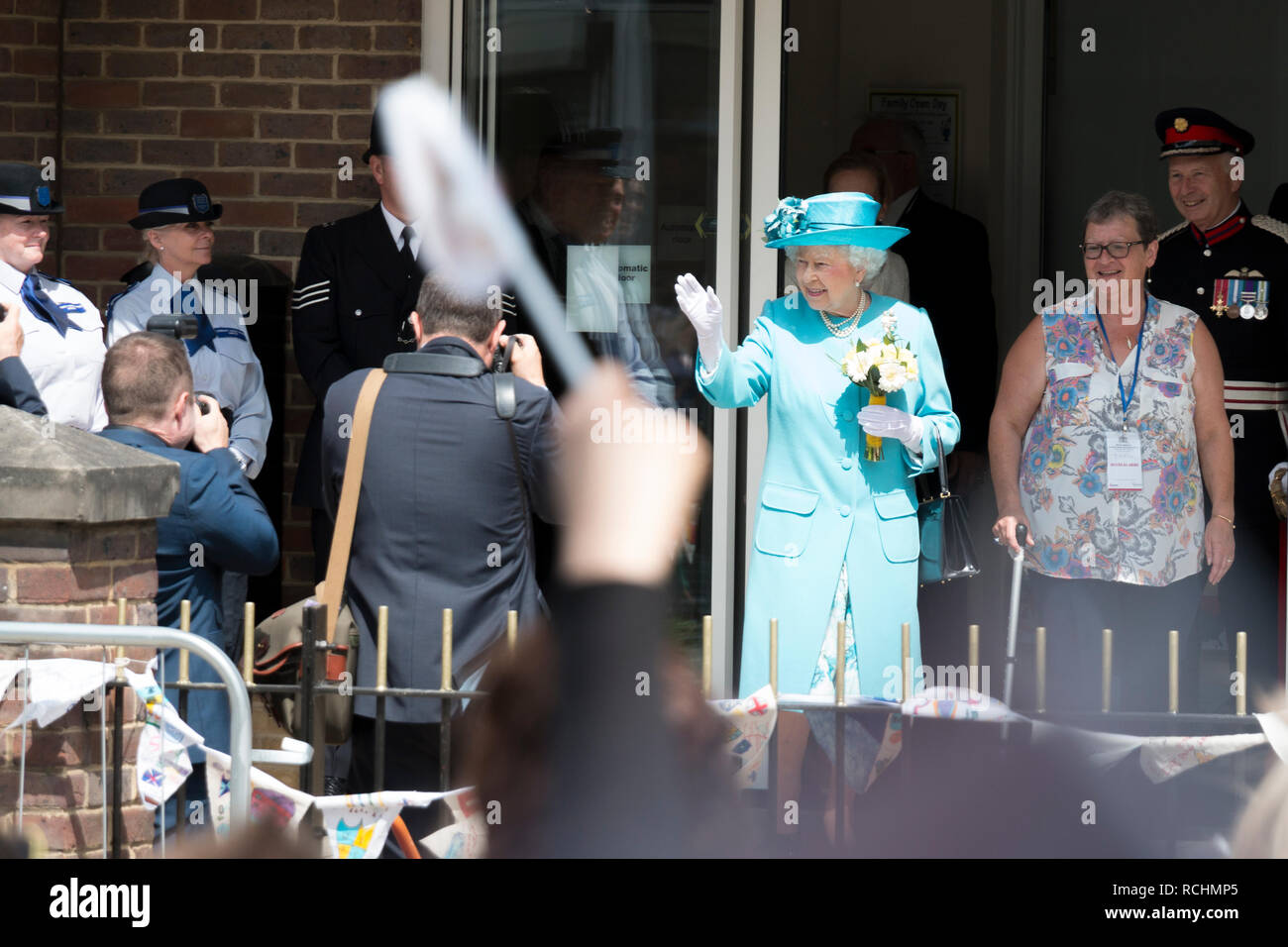 Elizabeth 2 queen of Britain waving to a crowd of people while visiting ...