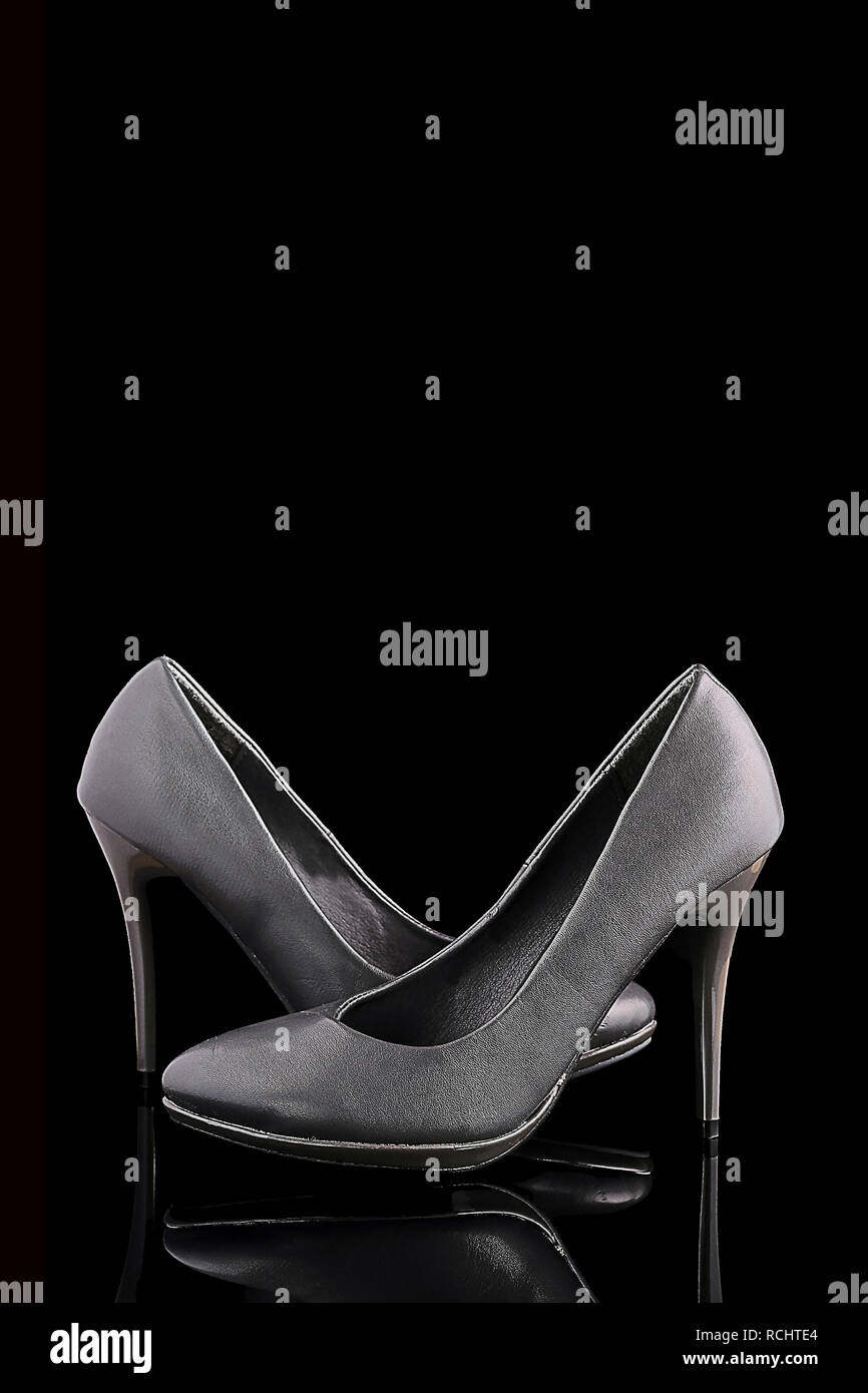 Gray Pumps on Black Background Stock Photo - Alamy