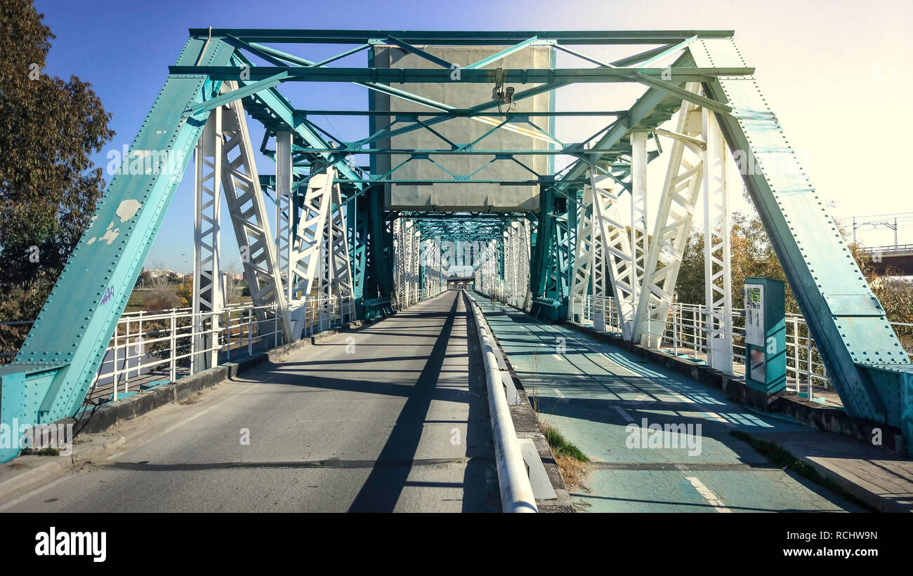 An old iron bridge with bike path, is shown after being converted to ...