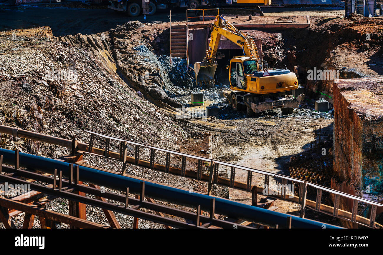 Hydraulic Excavator or wheel backhoe working in mining industry, mining ...