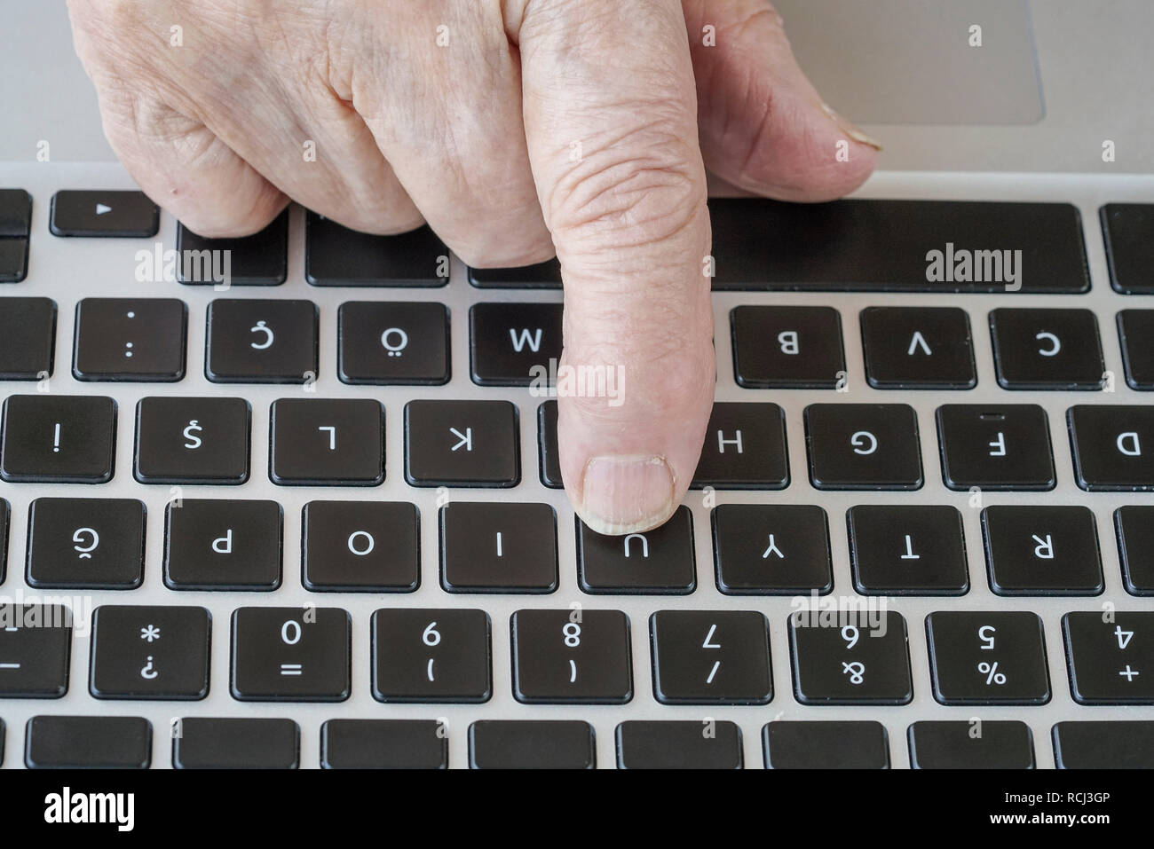 Closeup of a wrinkled hand on keyboard of a computer Stock Photo - Alamy