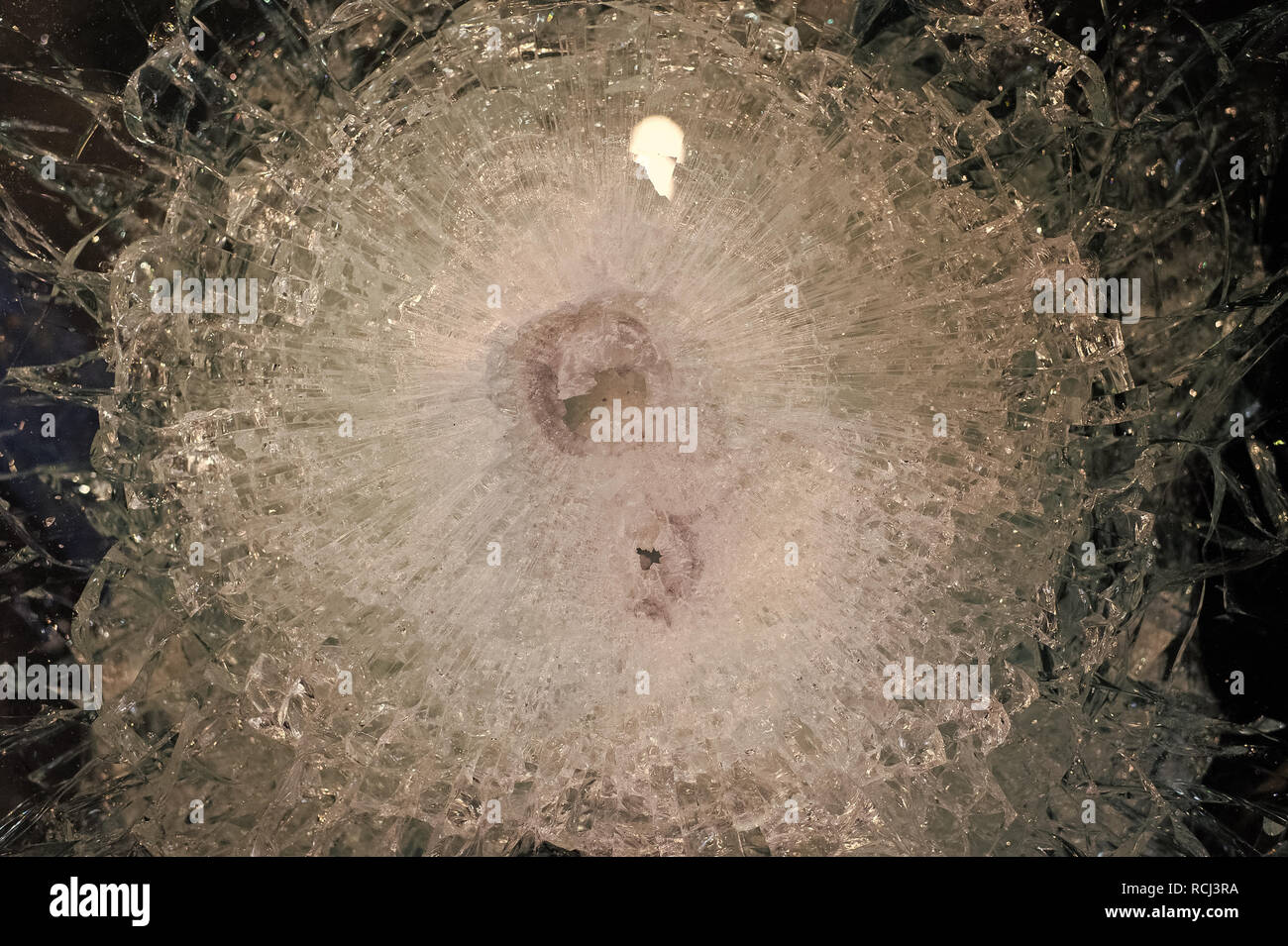 Bulletproof glass after gunshot, close up. Bulletproof glass destroyed ...