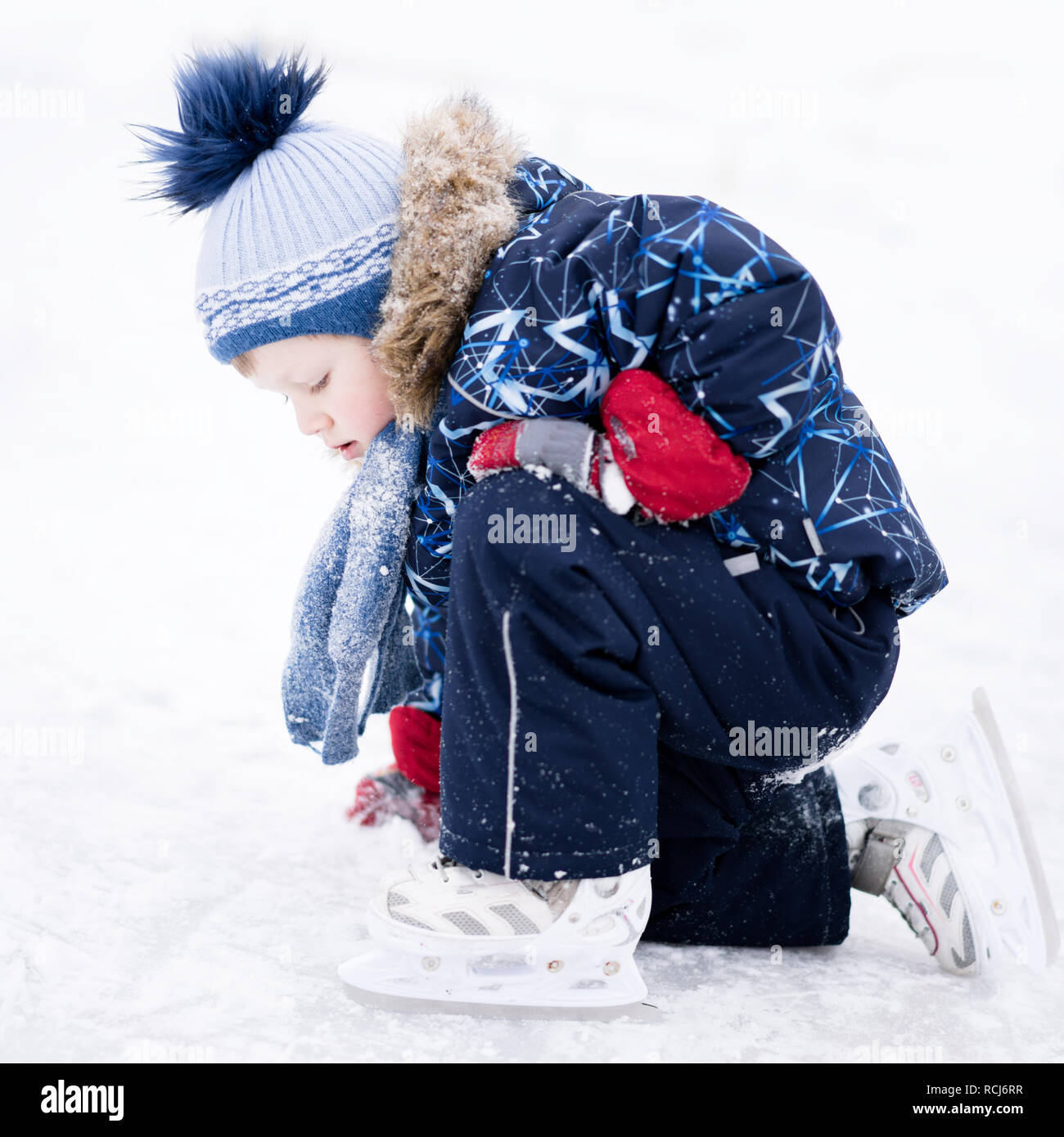 active winter holiday - cute little boy skating on an ice rink Stock ...