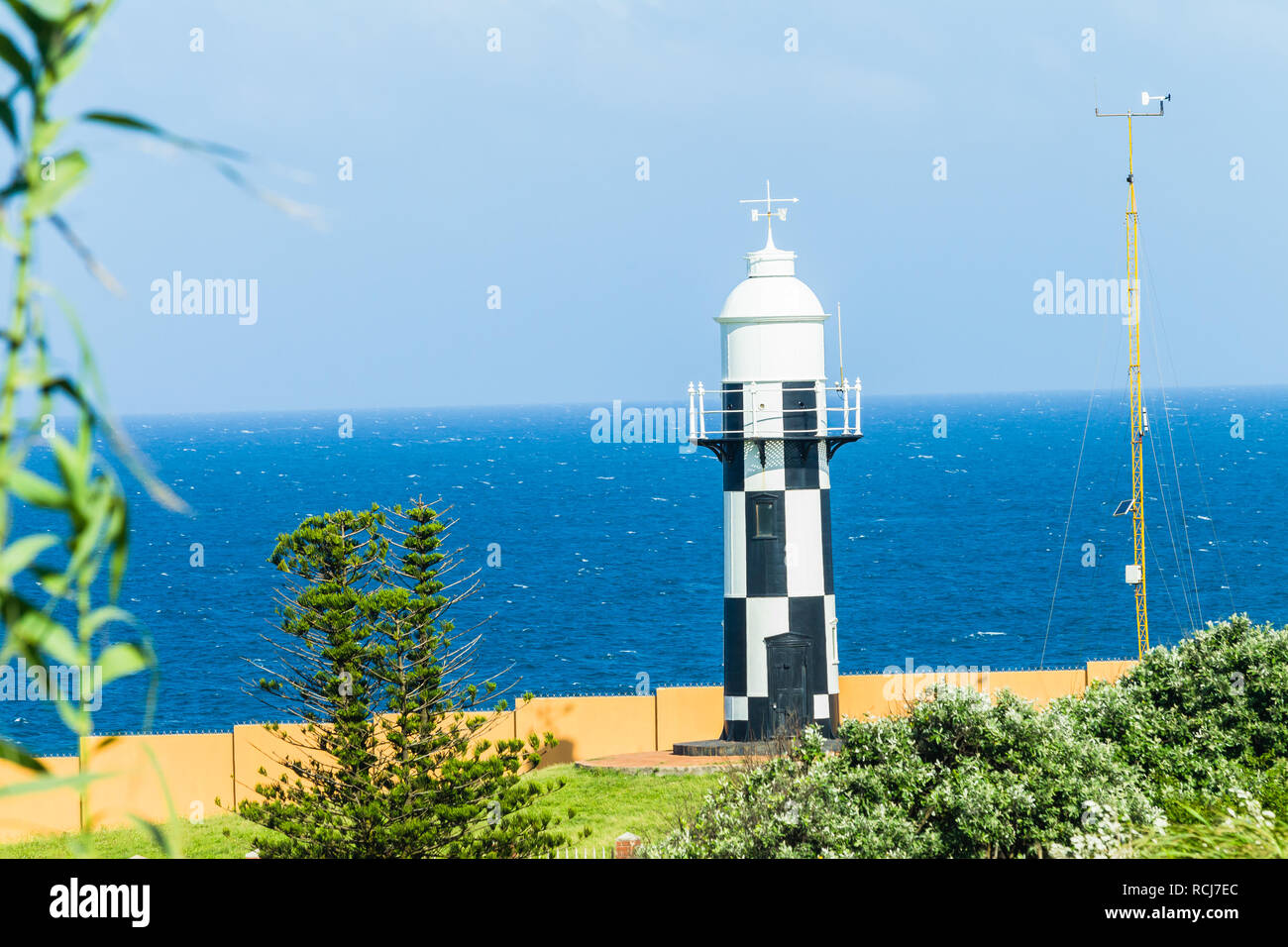Lighthouse beacon black and white structure on headland point ...