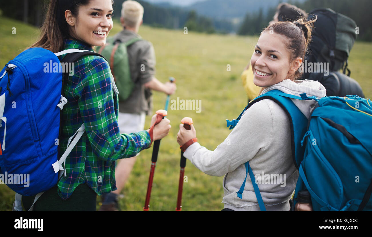 Group of young friends hiking in countryside. Multiracial young people ...