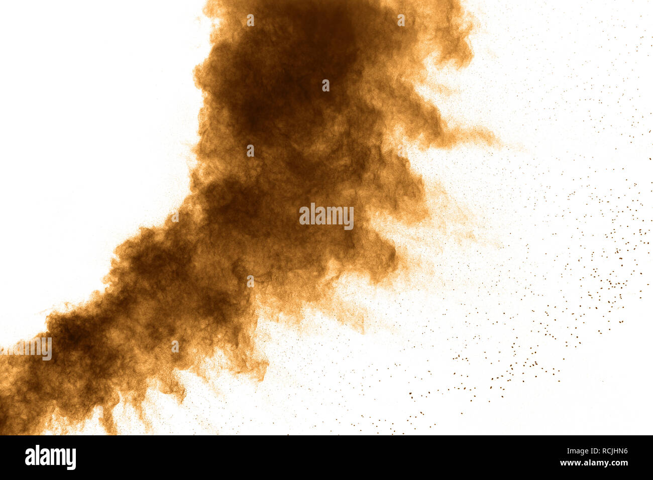 Abstract deep brown dust explosion on white background. Freeze motion ...