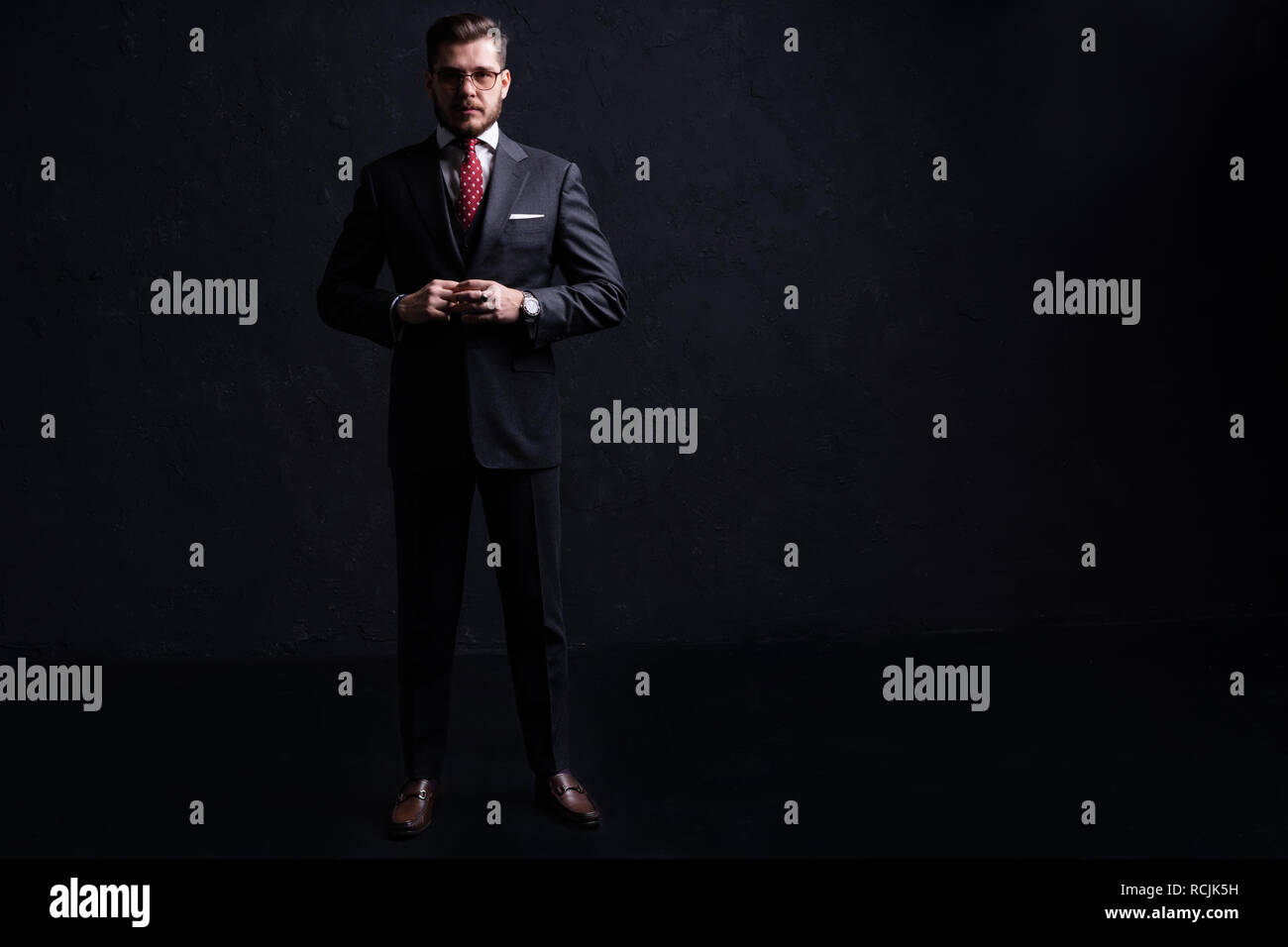 Full length portrait of a fashion male model over black background ...