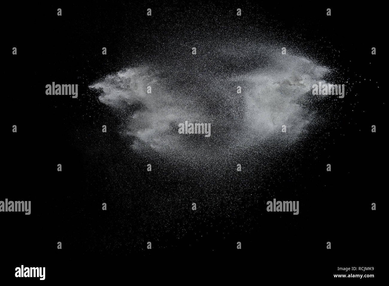 White talcume powder explosion on black background. White dust ...