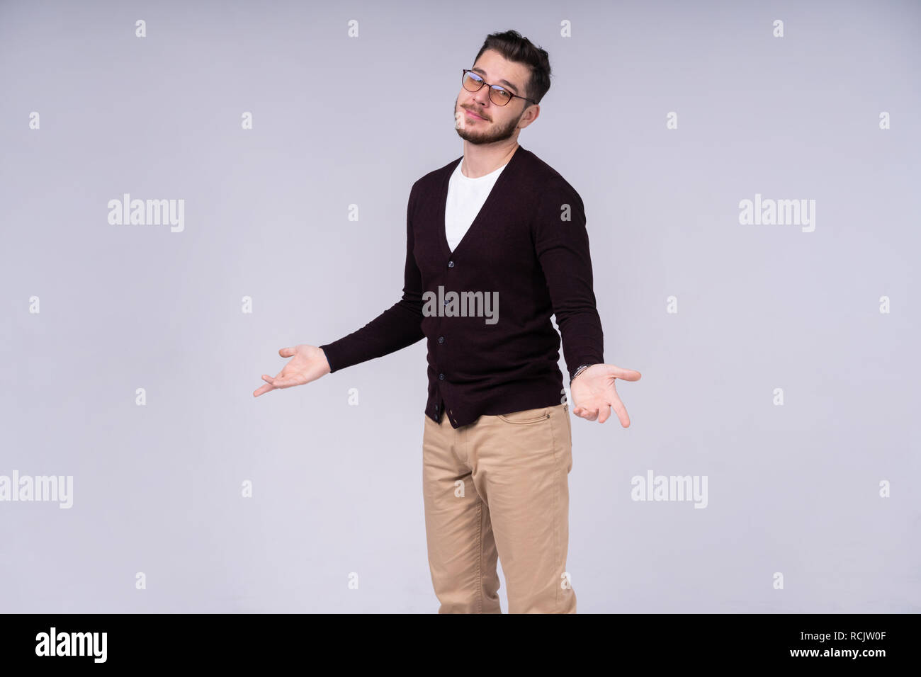 Portrait of sad upset young guy looking at camera over white background ...