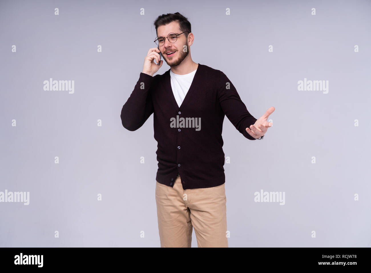 Image of happy young bearded emotional man standing over white wall ...